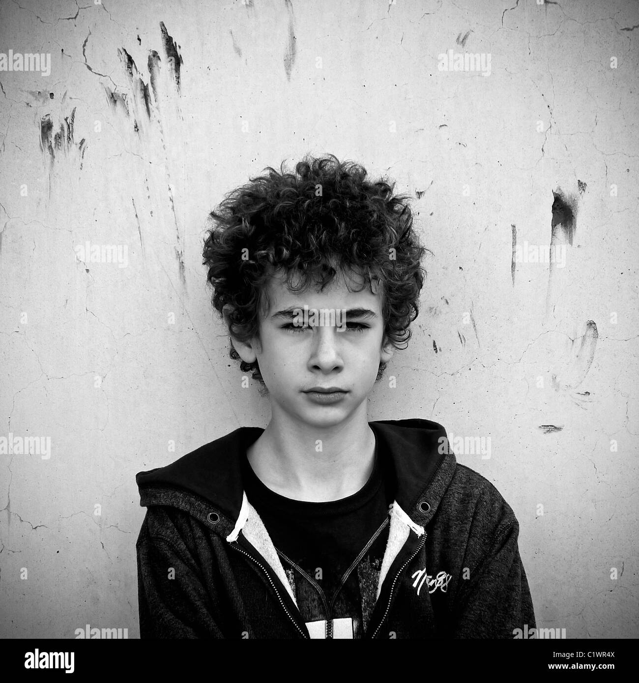 Serious pensive young boy leaning against urban wall Stock Photo - Alamy Serious pensive young boy leaning against urban wall Stock Photo - Alamy