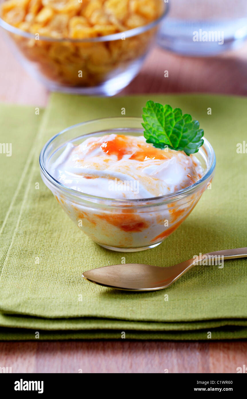 Bowl of yogurt, corn flakes in the background Stock Photo - Alamy
