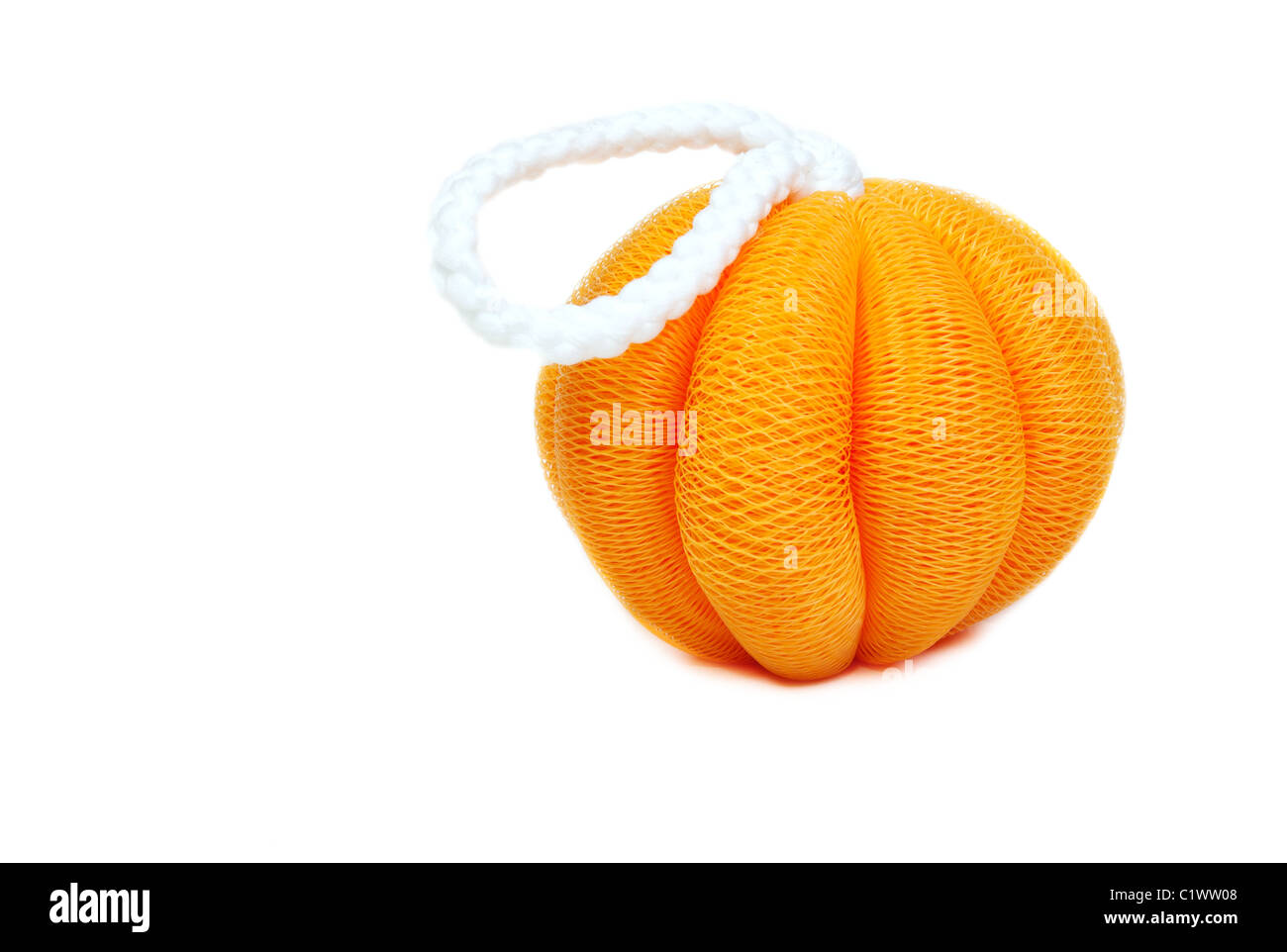 Yellow sponge in the shape of a pumpkin on a white background Stock ...