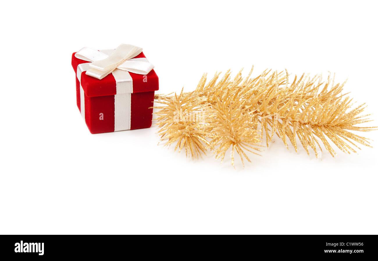 Red and gold gift box with fir branches on a white background Stock ...