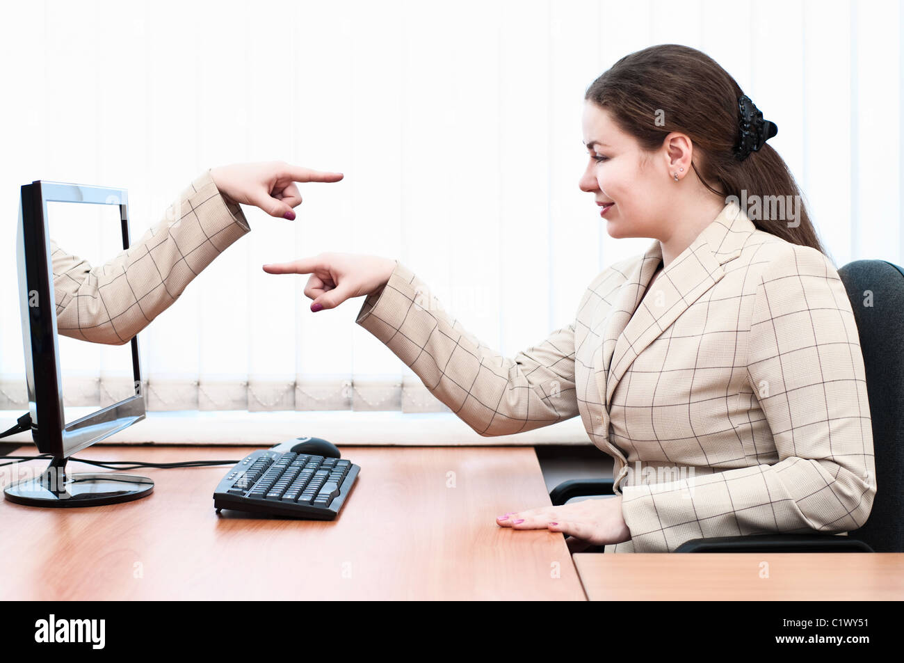 Young Caucasian woman point on monitor sitting at the working place ...