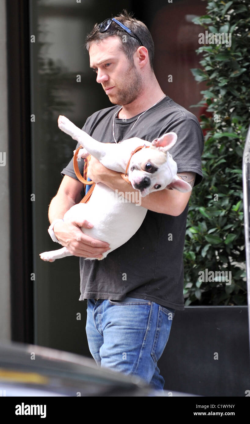 Tom Crane leaves his hotel with girlfriend Sarah Harding's dog Corker ...