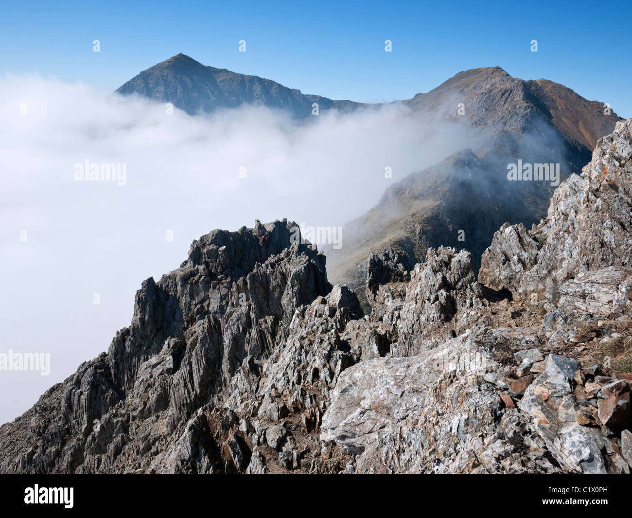 Yr Wyddfa, the summit of Snowdon and Garnedd Ugain seen above a cloud ...