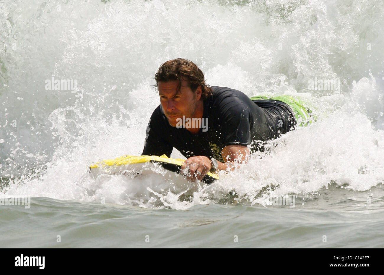 Dean McDermott goes for a surf on Malibu Beach. Los Angeles, California ...
