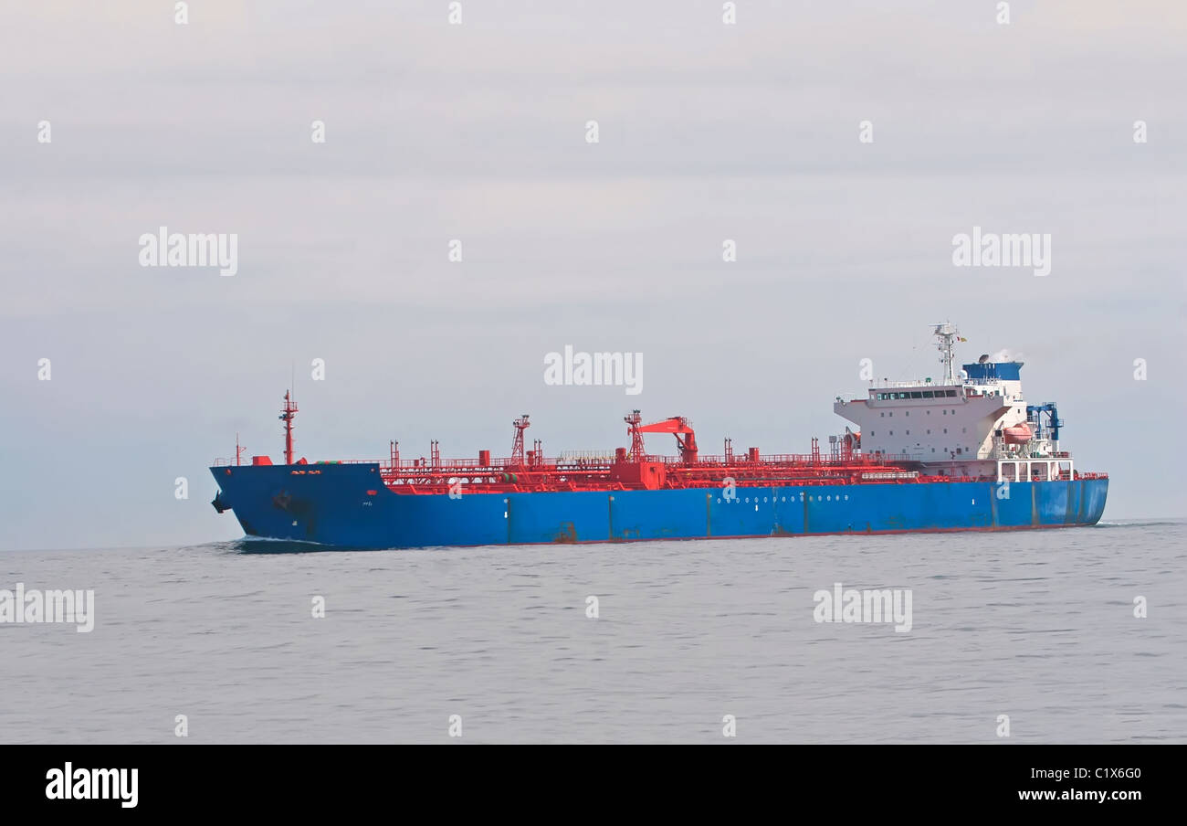Tanker sailing in the sea with water splashes Stock Photo - Alamy