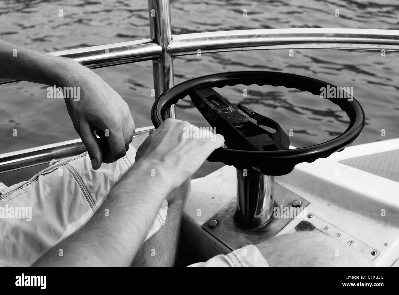 Driving a boat Stock Photo - Alamy