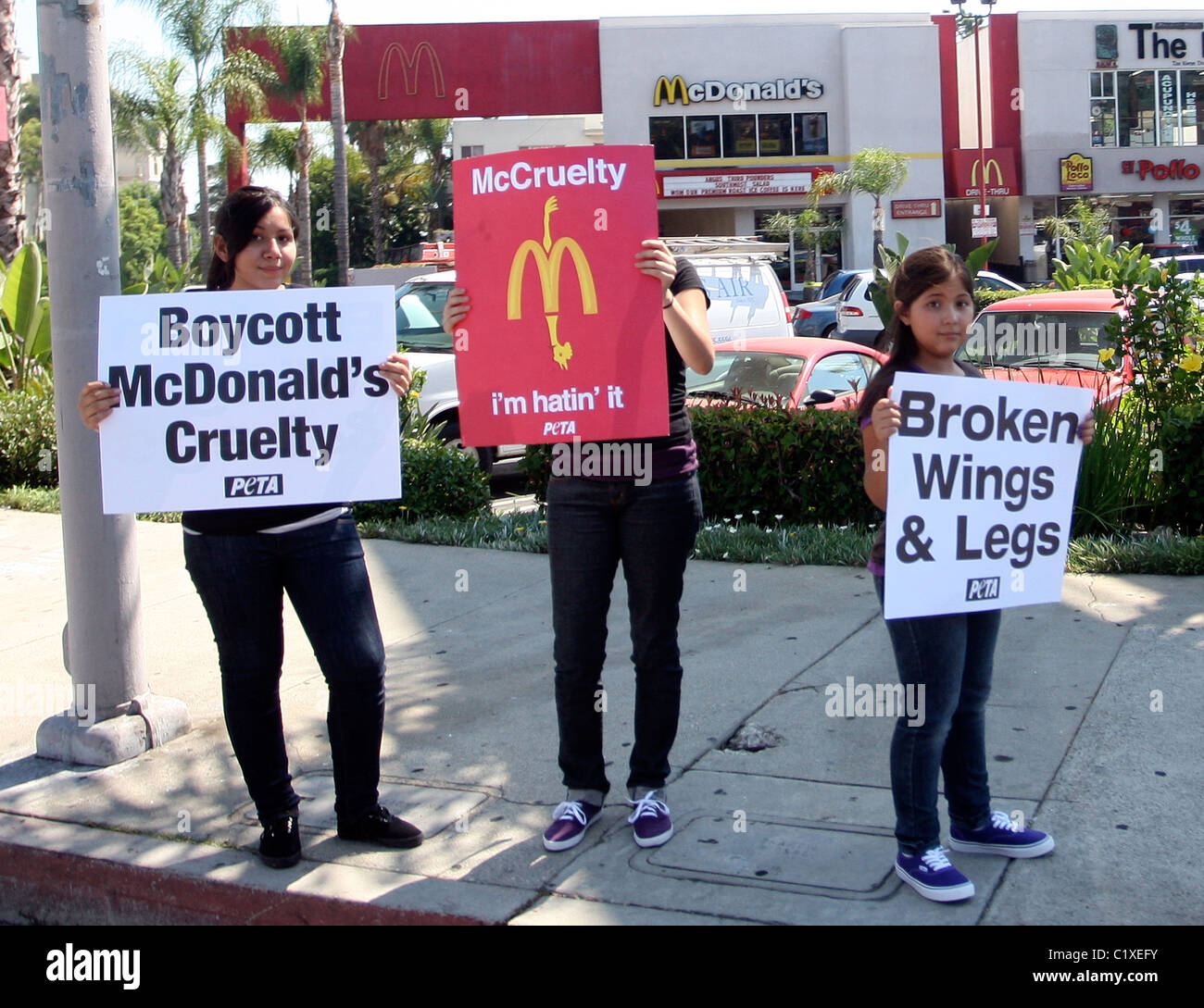 Protesters stand outside a McDonalds restaurant in a bid to trigger a ...