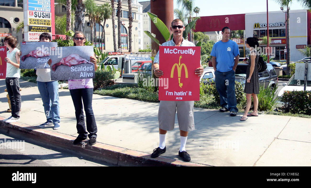 Protesters stand outside a McDonalds restaurant in a bid to trigger a ...