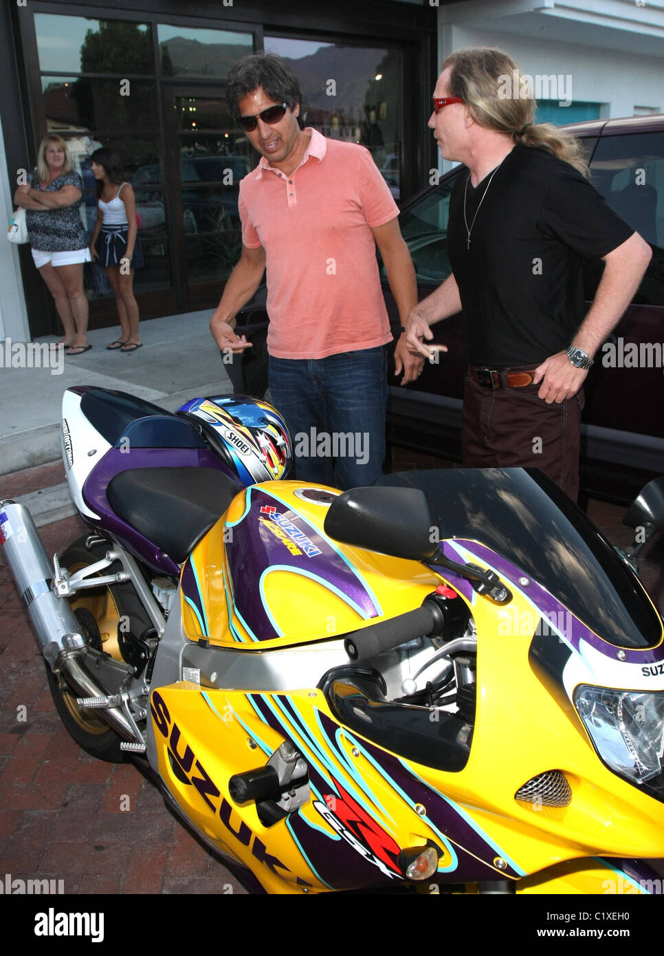 Ray Romano talks to a fan about his motorcycle as he leaves Nobu ...