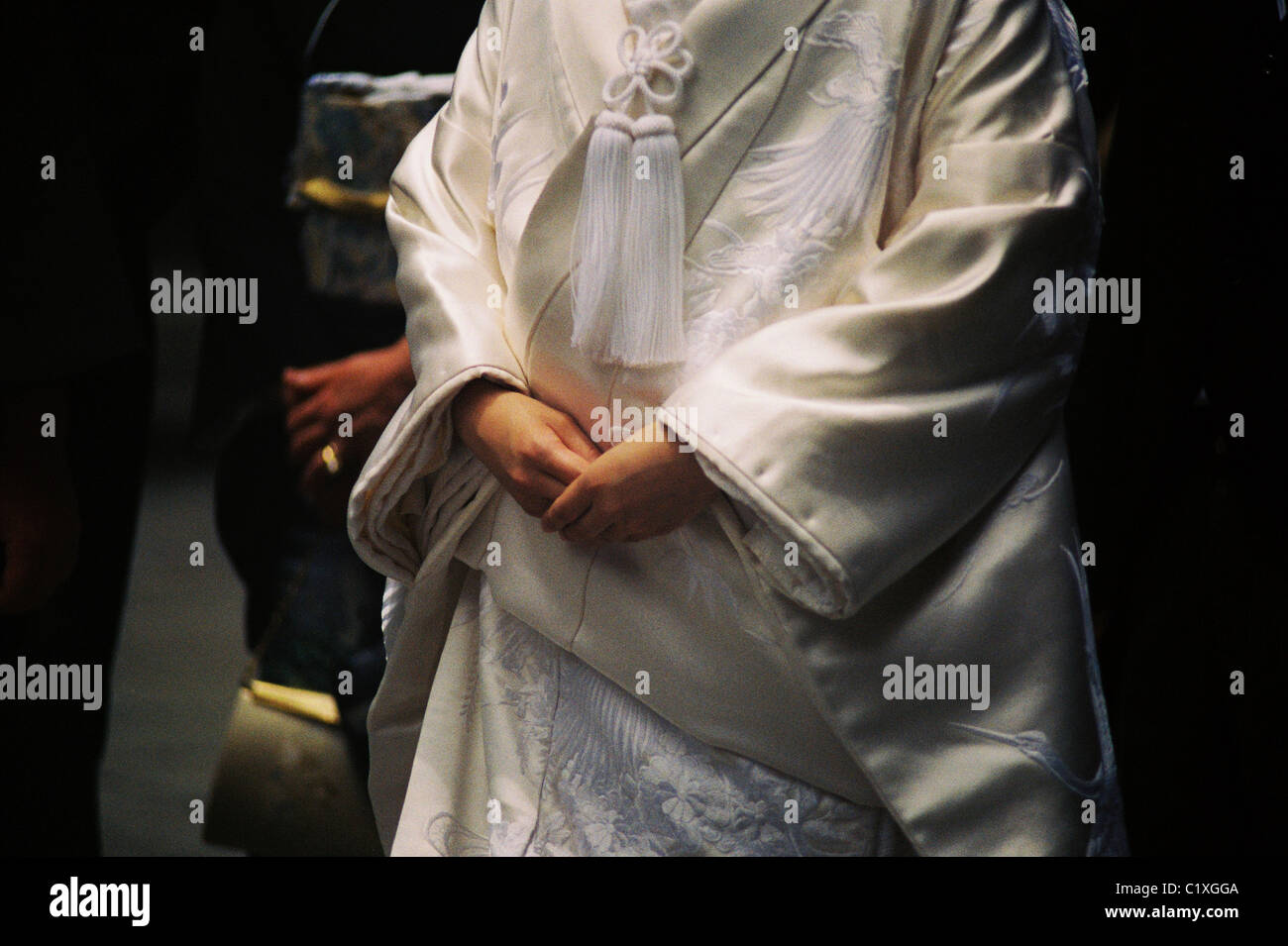 Detail of the bride's hands and white wedding kimono during a ...