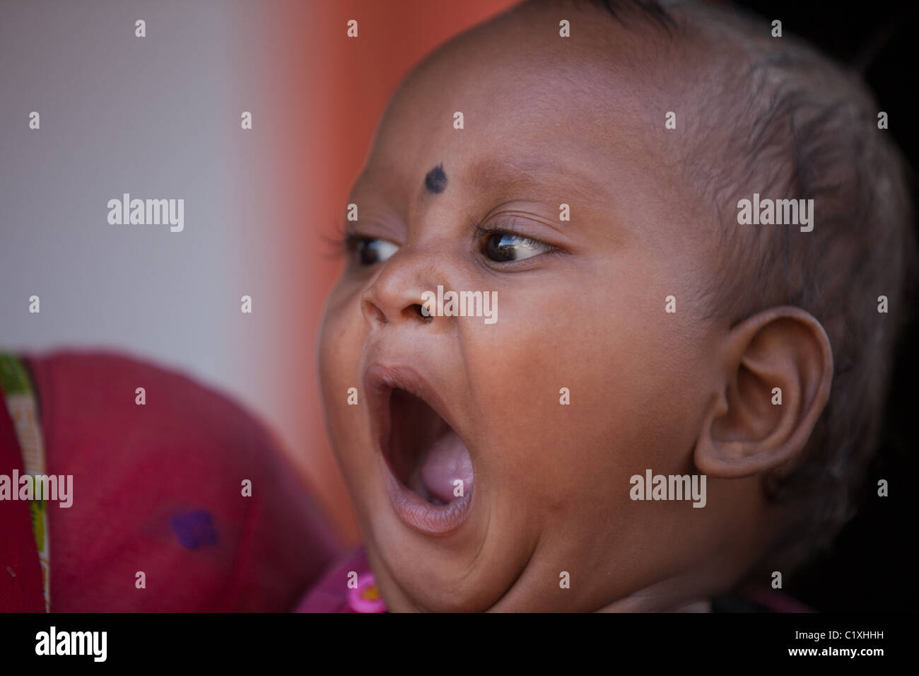 baby giving a yawn Andhra Pradesh South India Stock Photo - Alamy