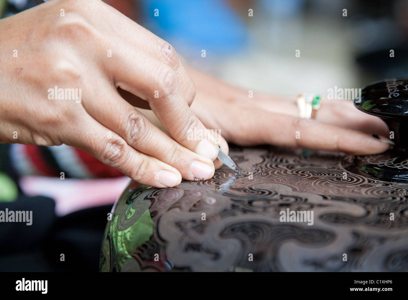 Lacquer manufacture in Bagan, Burma. Woman is engraving by lancet ...