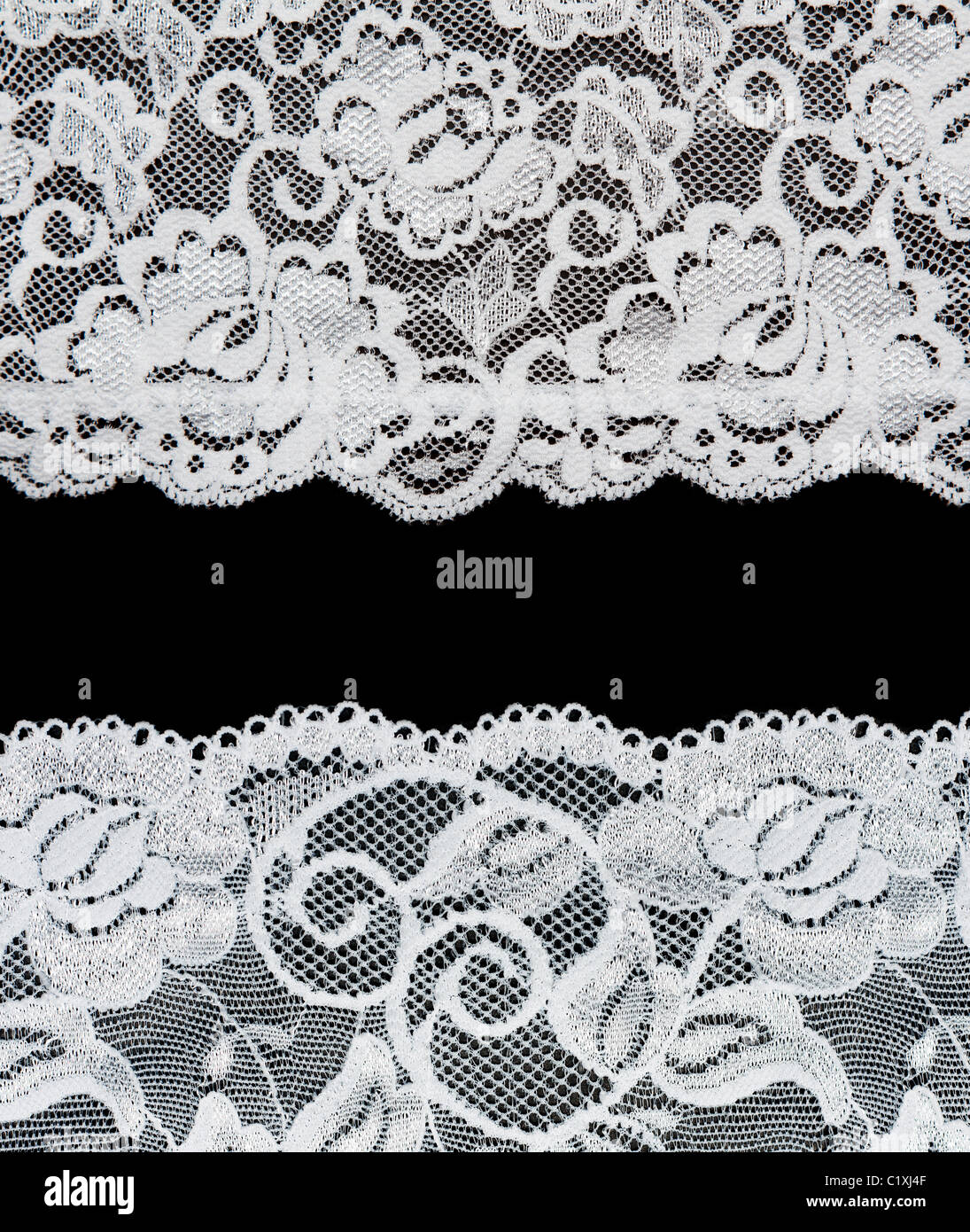Decorative lace with pattern on black background. Picture is formed ...