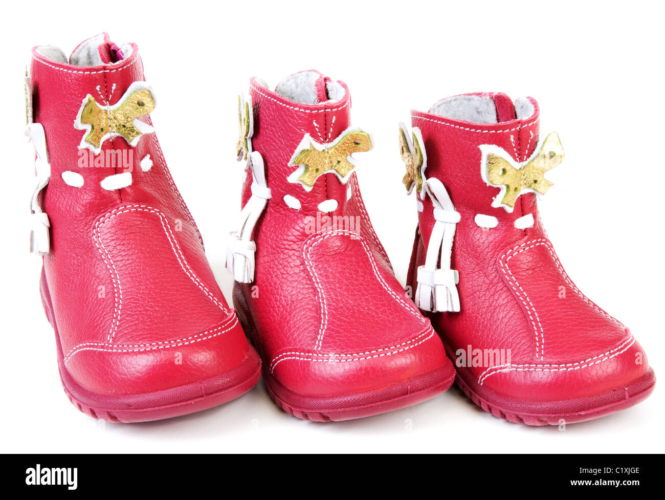 Red leather baby boots on white background Stock Photo - Alamy