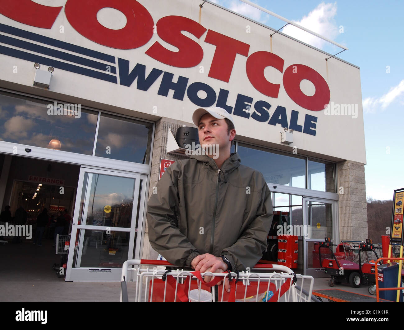 A man with shopping cart outside of Costco Wholesale, a USA big box ...