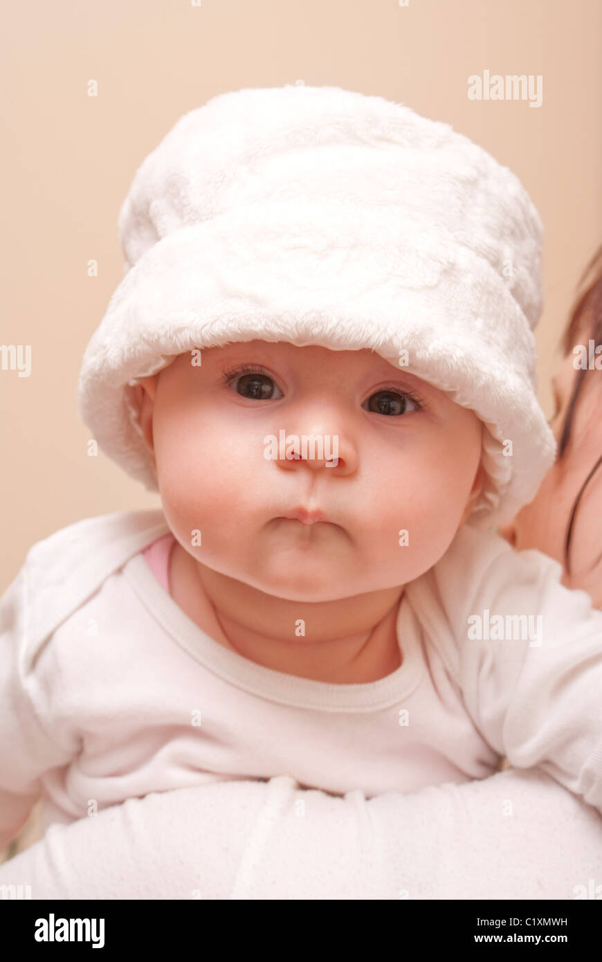 Baby girl in furry hat Stock Photo - Alamy