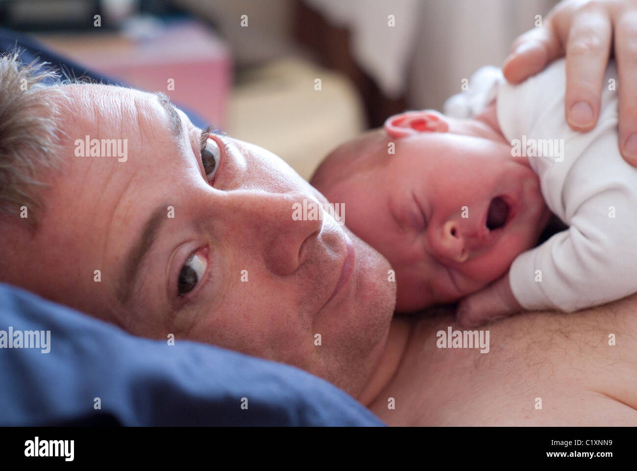 Dad and yawning baby daughter Stock Photo - Alamy