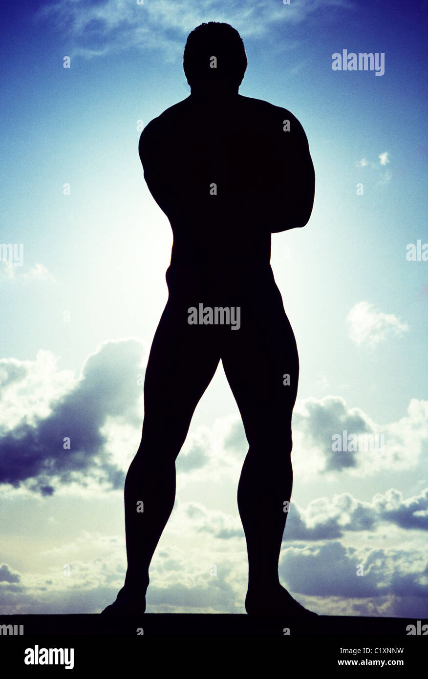 Bodybuilder silhouetted against the sky Stock Photo - Alamy