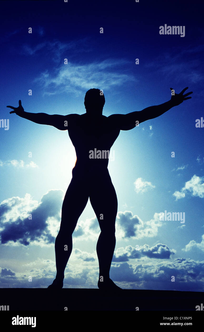 Bodybuilder silhouetted against the sky Stock Photo - Alamy
