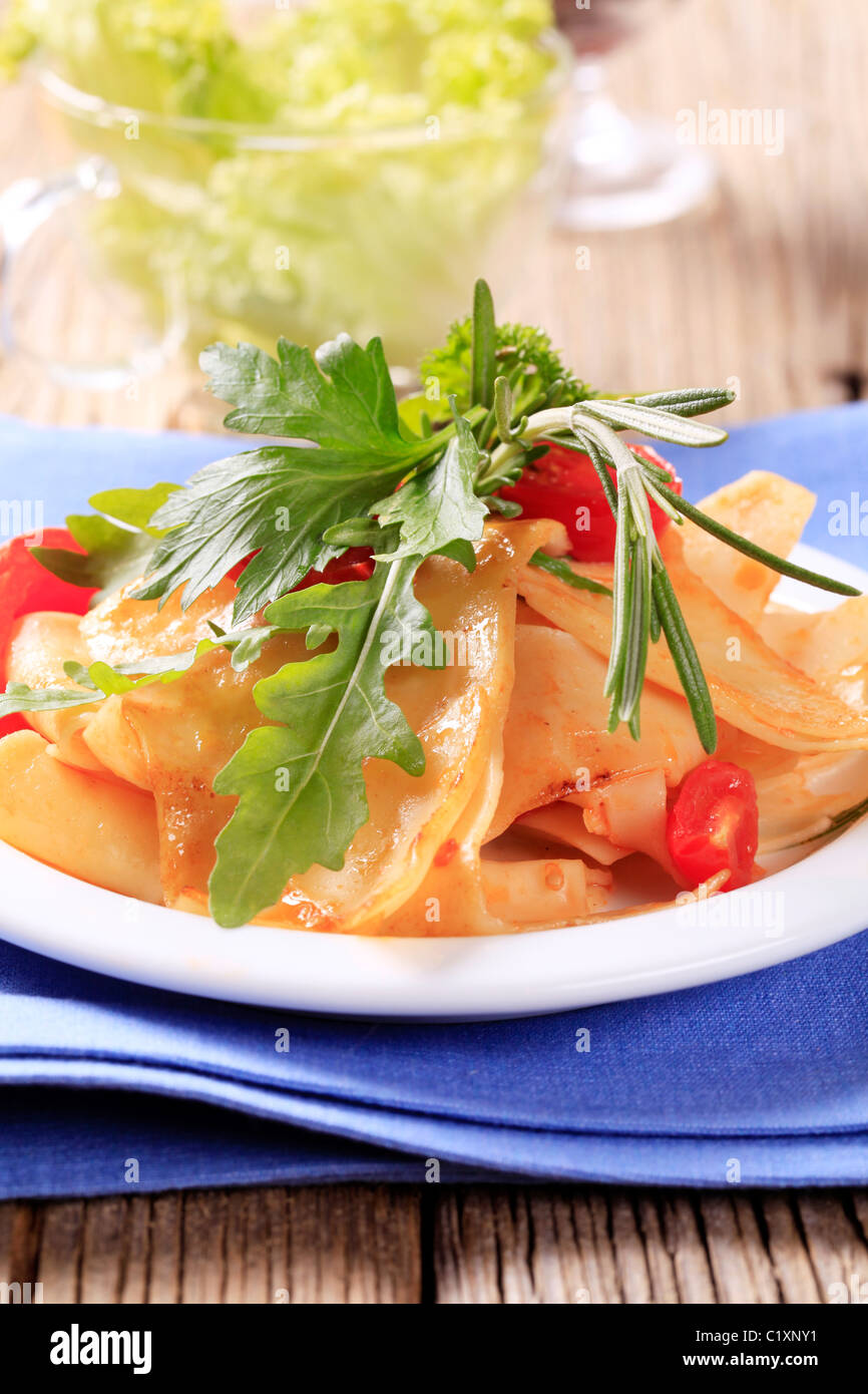Sheet pasta with tomatoes and salad greens Stock Photo - Alamy