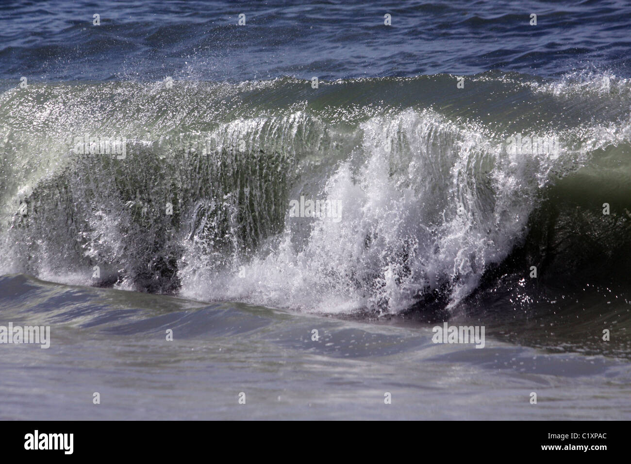 View of the breaking of a strong wave on the beach Stock Photo - Alamy