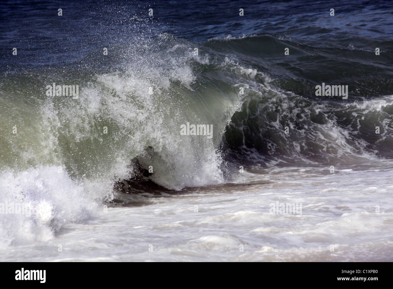 View of the breaking of a strong wave on the beach Stock Photo - Alamy
