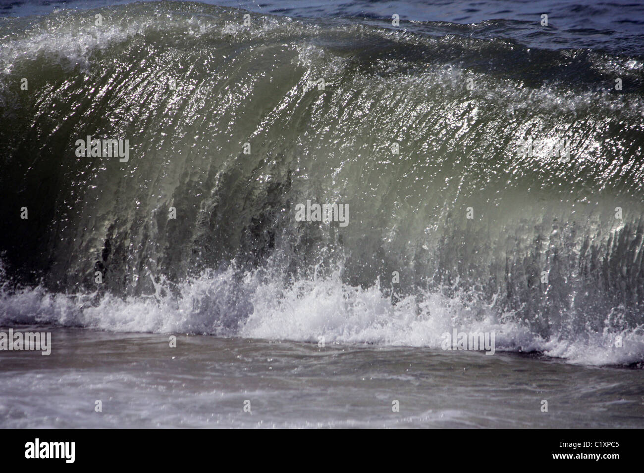 View of the breaking of a strong wave on the beach Stock Photo - Alamy