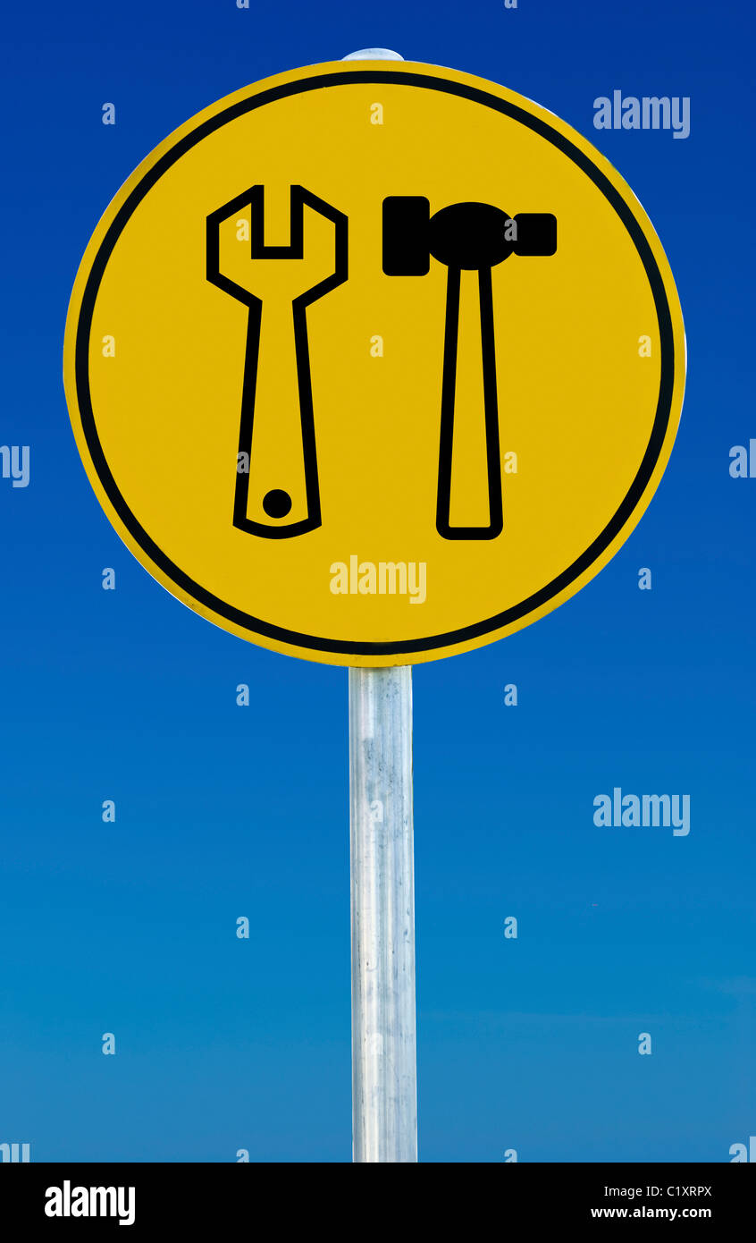 A tools sign isolated on a blue graduated sky Stock Photo - Alamy