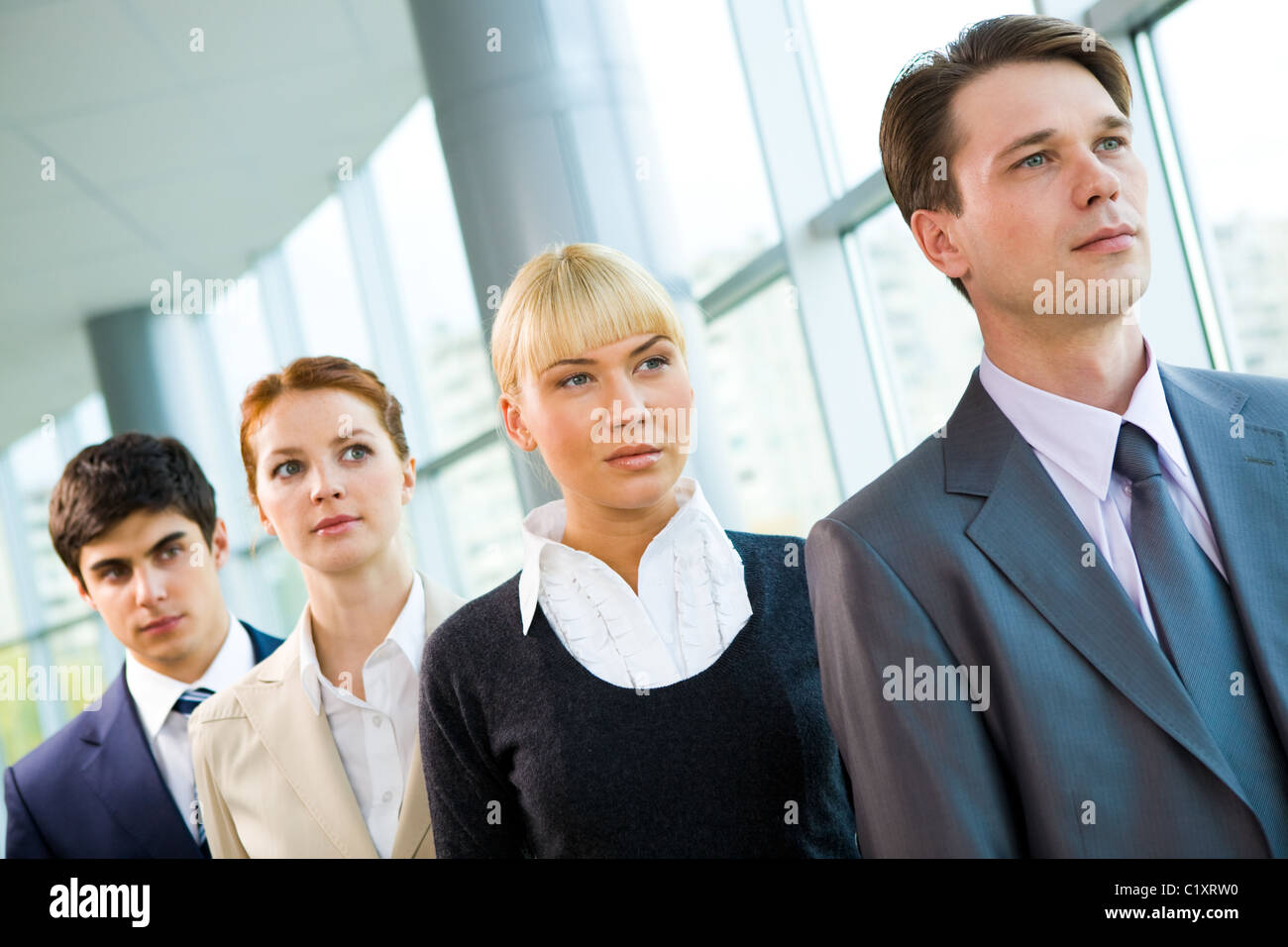 Portrait of friendly business group standing in line Stock Photo - Alamy