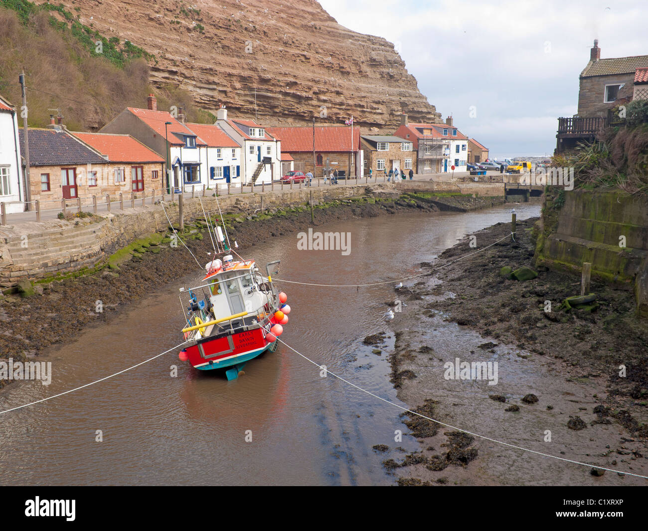 A fishing boat by Roxby Beck Staithes North Yorkshire Stock Photo - Alamy