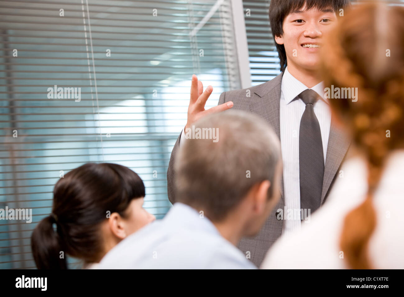 Photo of several employees during presentation with focus on their ...