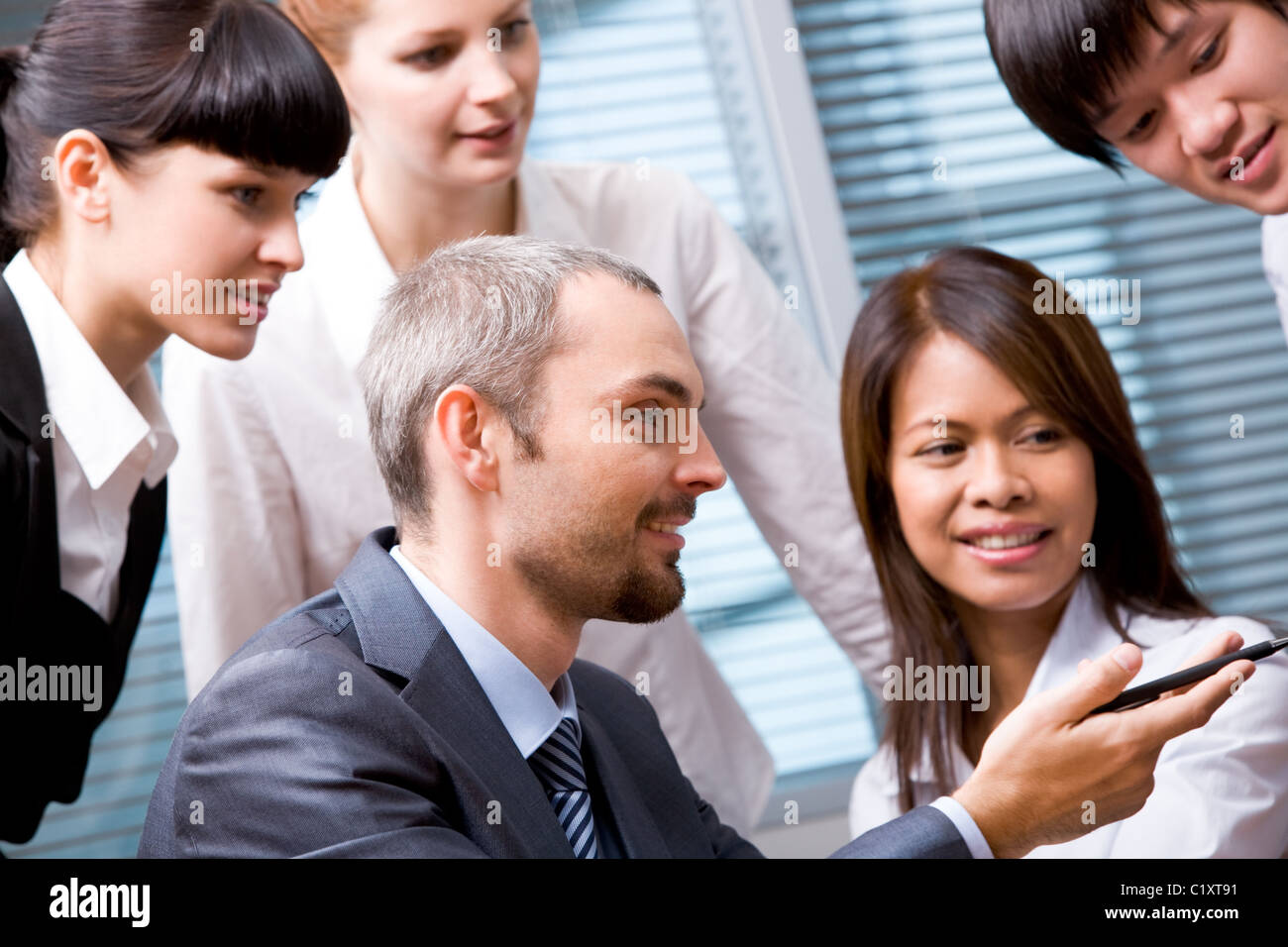Portrait of executive employees interacting in office Stock Photo - Alamy