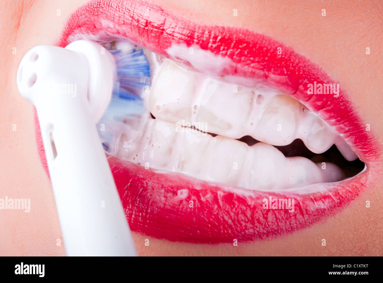 white teeth are brushed with an electric toothbrush Stock Photo - Alamy