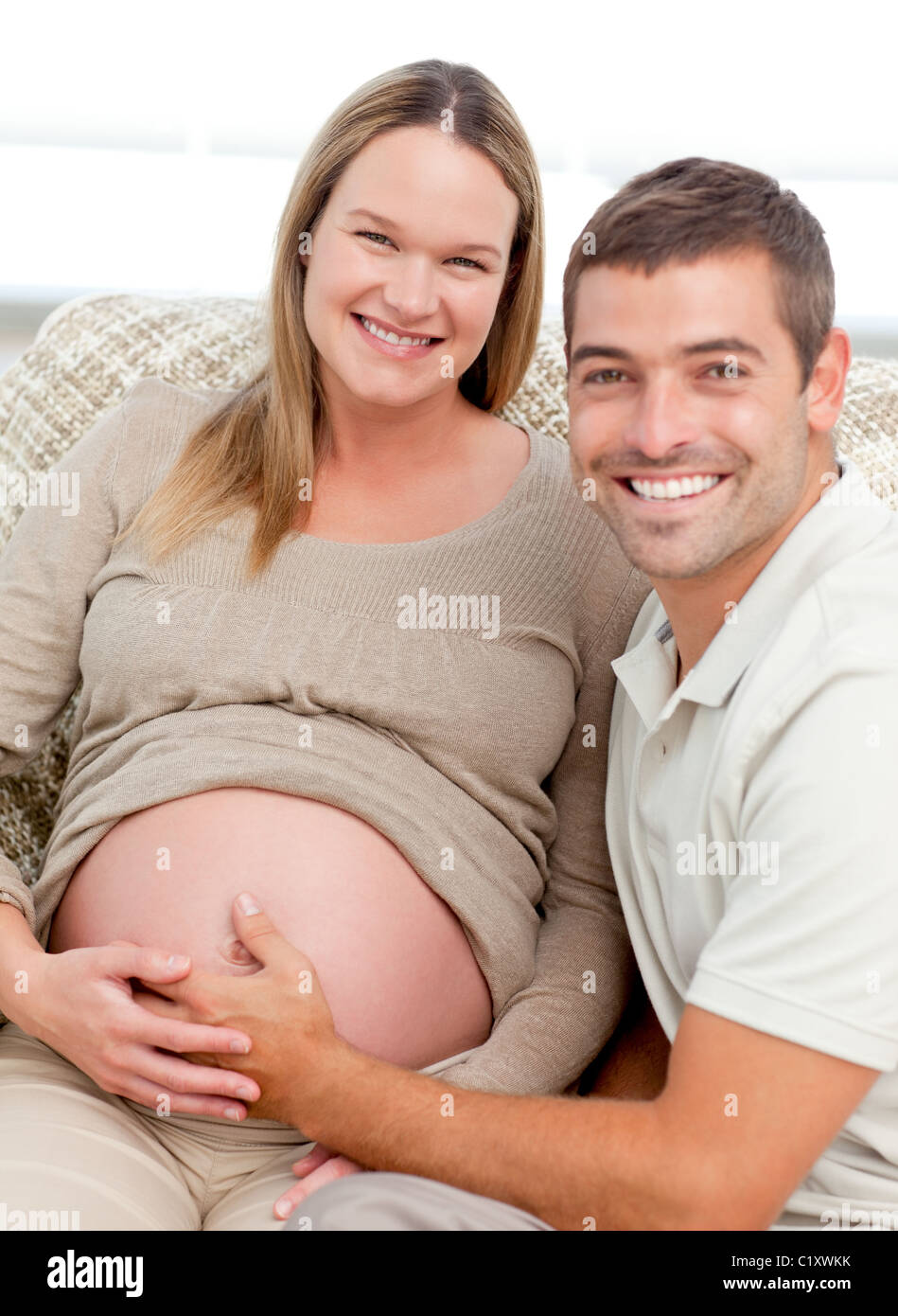 Portrait of future parents in the living room Stock Photo - Alamy