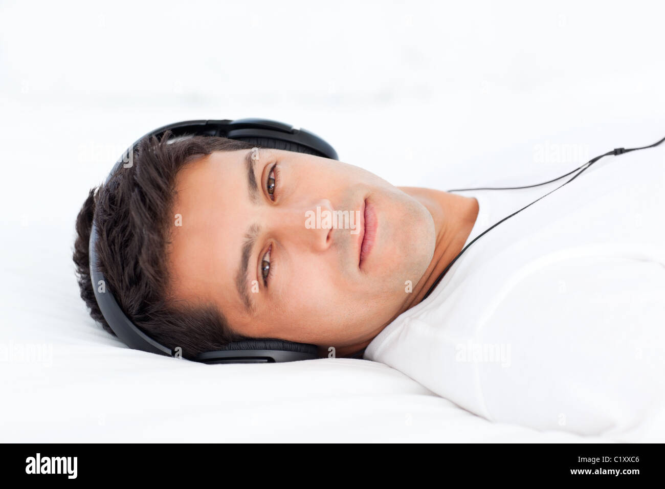 Man lying on the bed Cut Out Stock Images & Pictures - Alamy