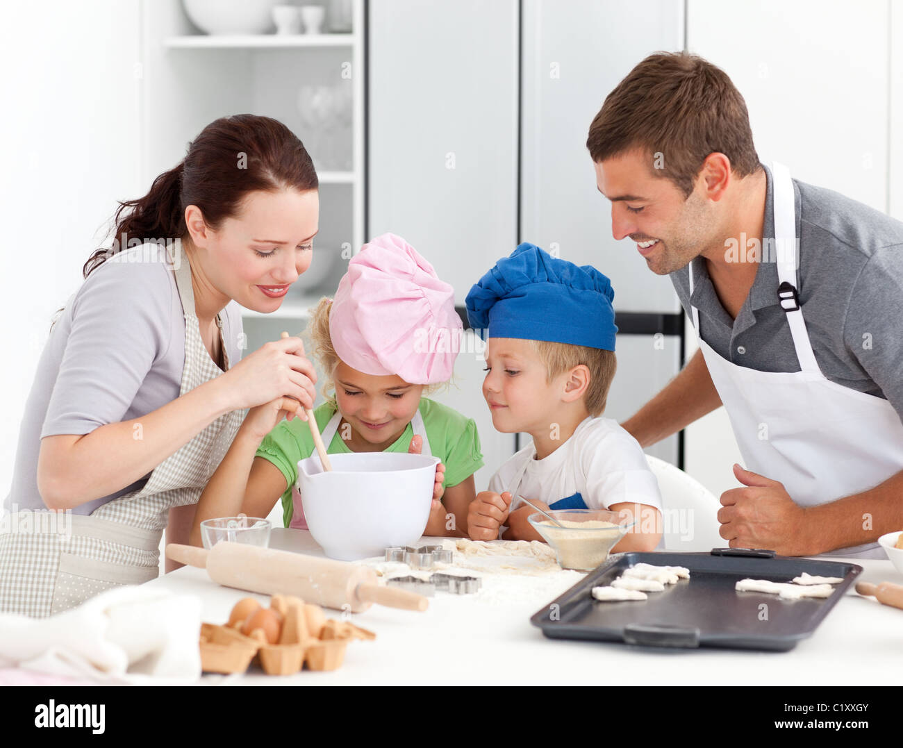 Adorable family baking together in the kitchen Stock Photo - Alamy