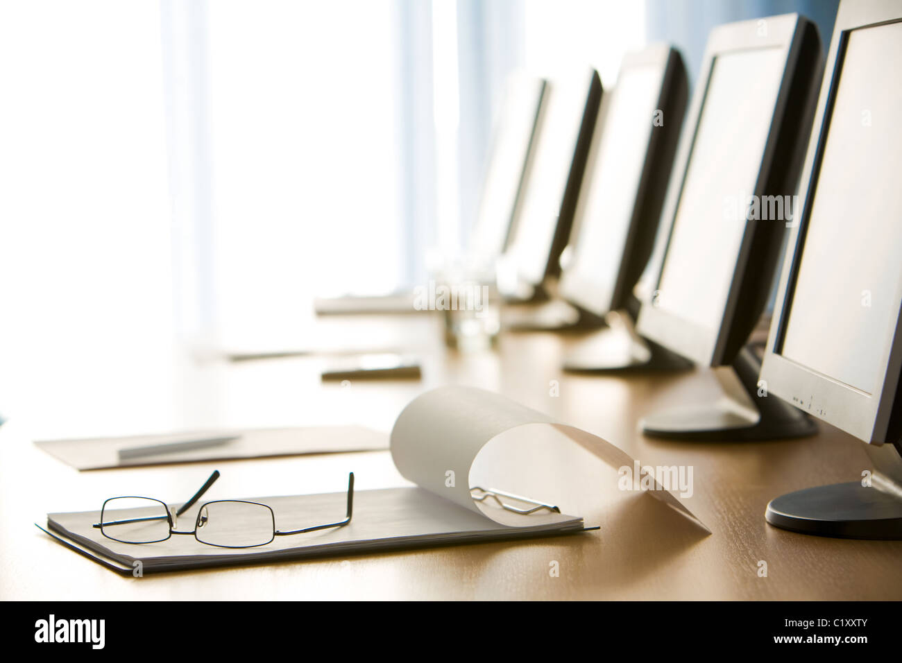 Image of workplace with paper, eyeglasses and monitors near by Stock ...