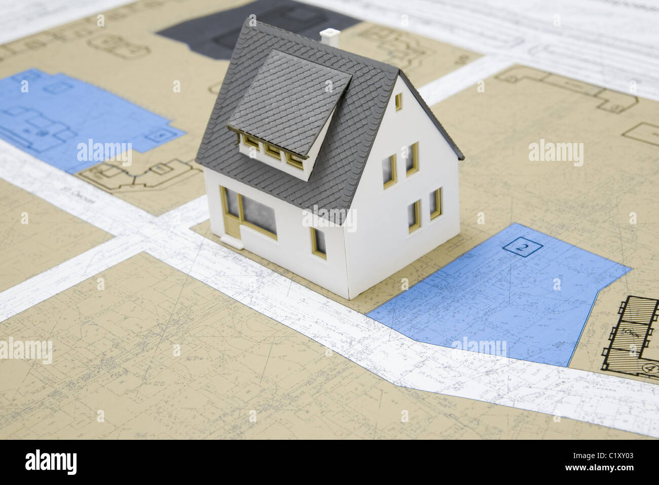 Close-up of toy house model on blueprints with its design Stock Photo ...