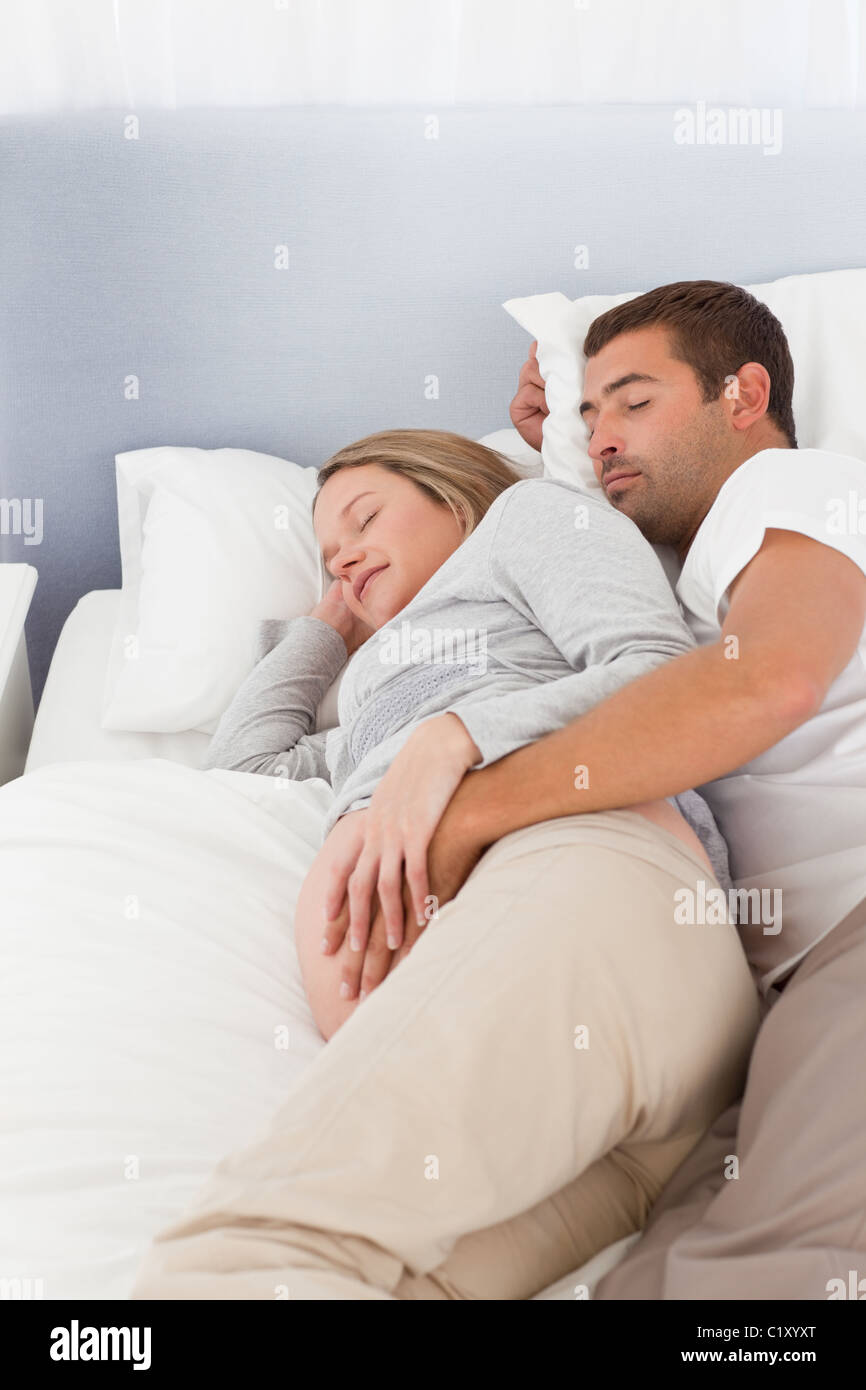 Lovely future parents sleeping in the bedroom Stock Photo - Alamy