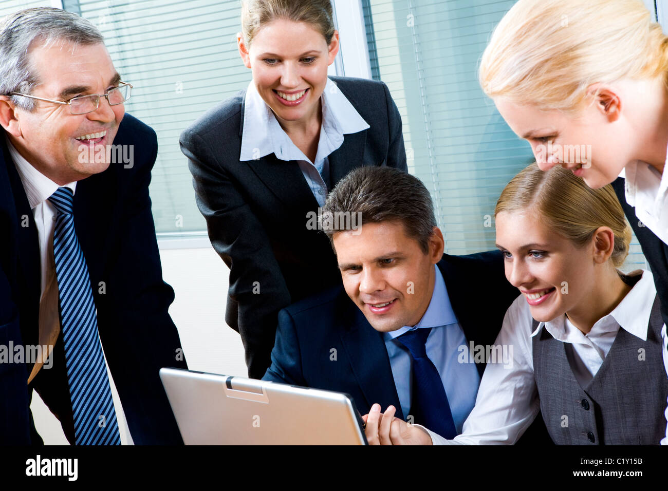 Portrait of confident co-workers interacting with each other at meeting ...