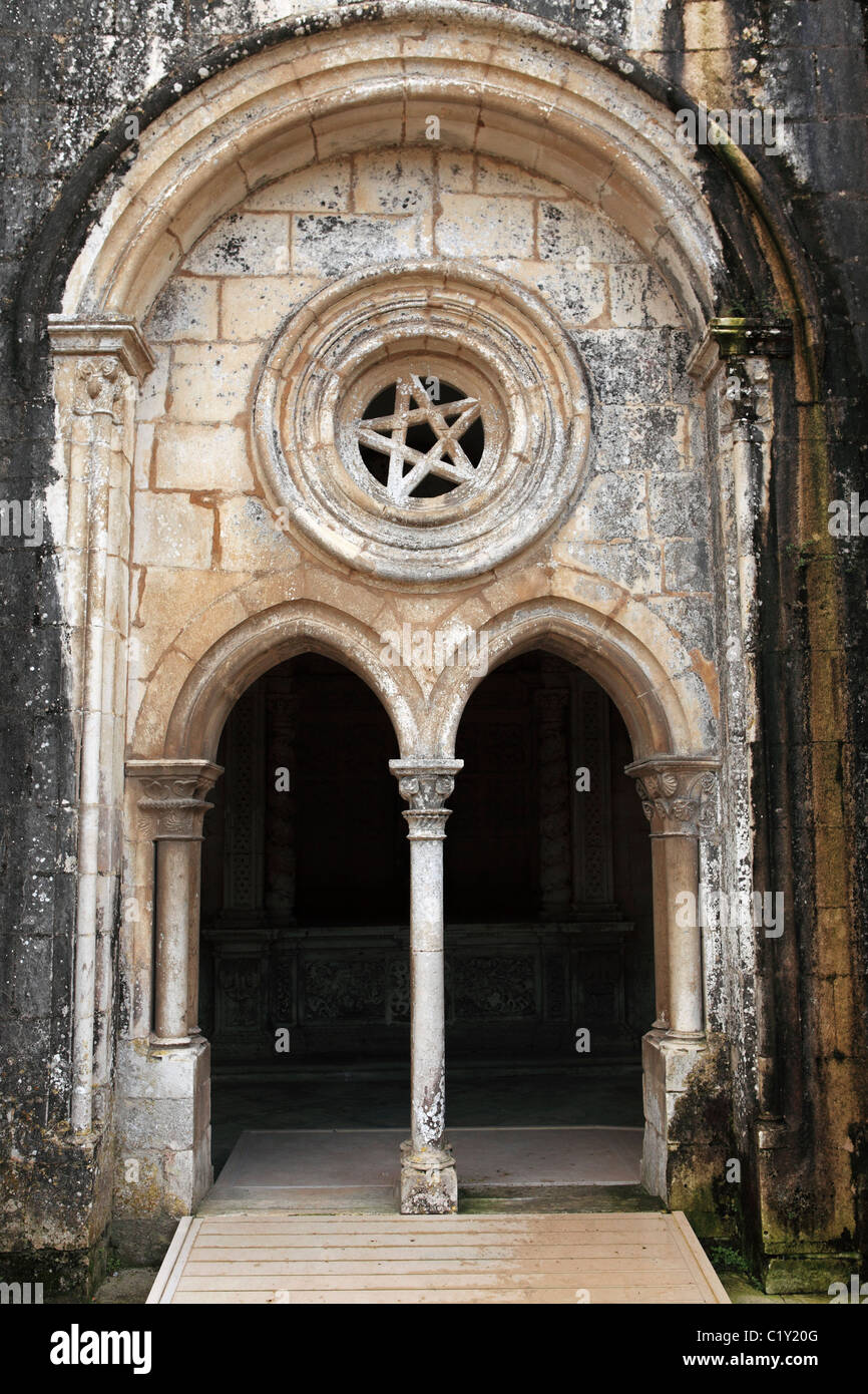 A pentagram is carved into a window above a door at Alcobaca Monastery ...