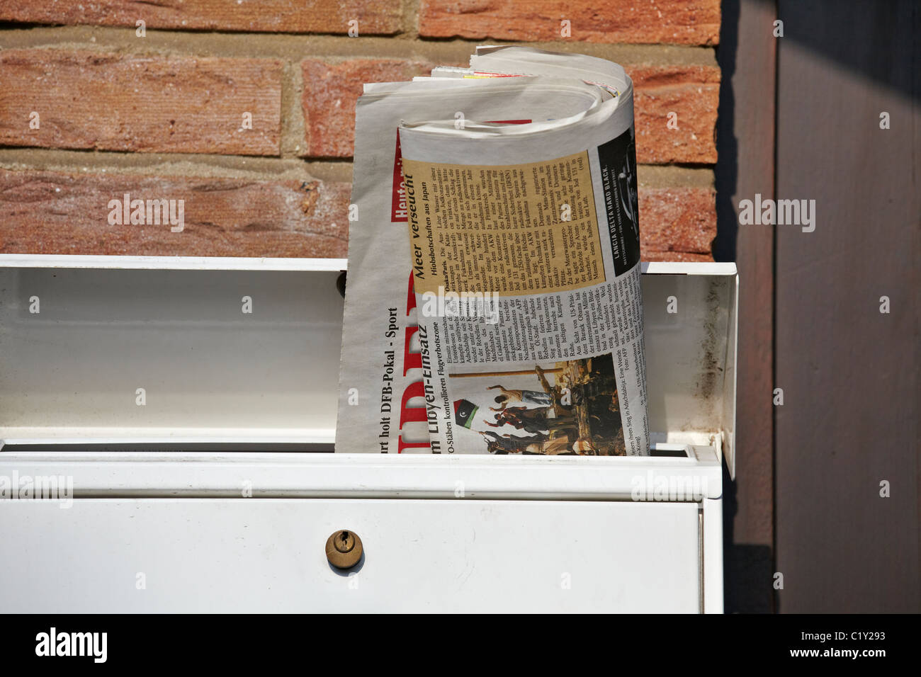 Closeup of a white mailbox with a newspaper Stock Photo - Alamy