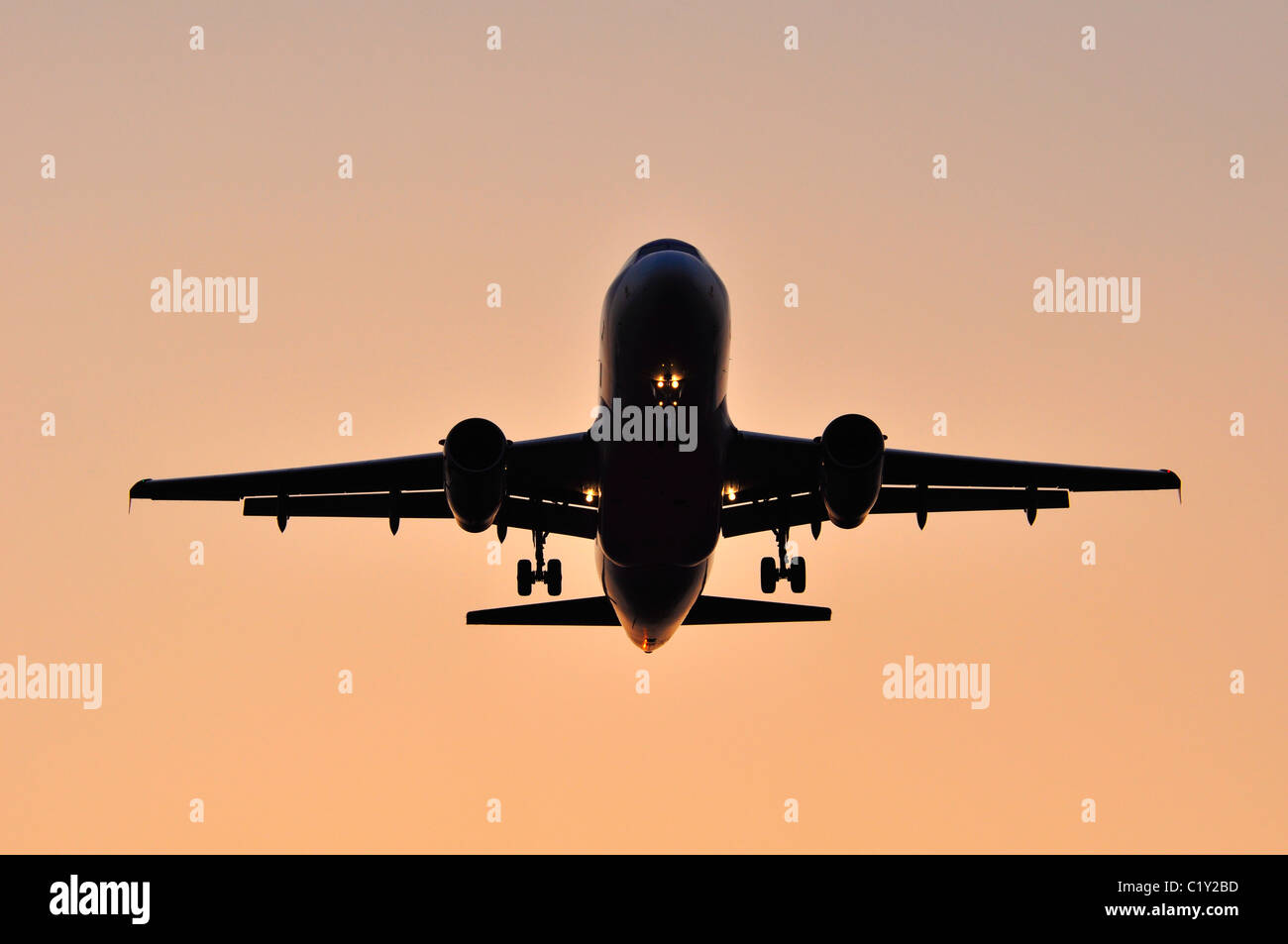 Airplane coming into Land during sunset at Heathrow Airport Stock Photo ...