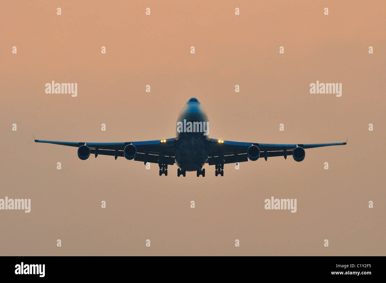 Airplane coming into Land during sunset at Heathrow Airport Stock Photo ...