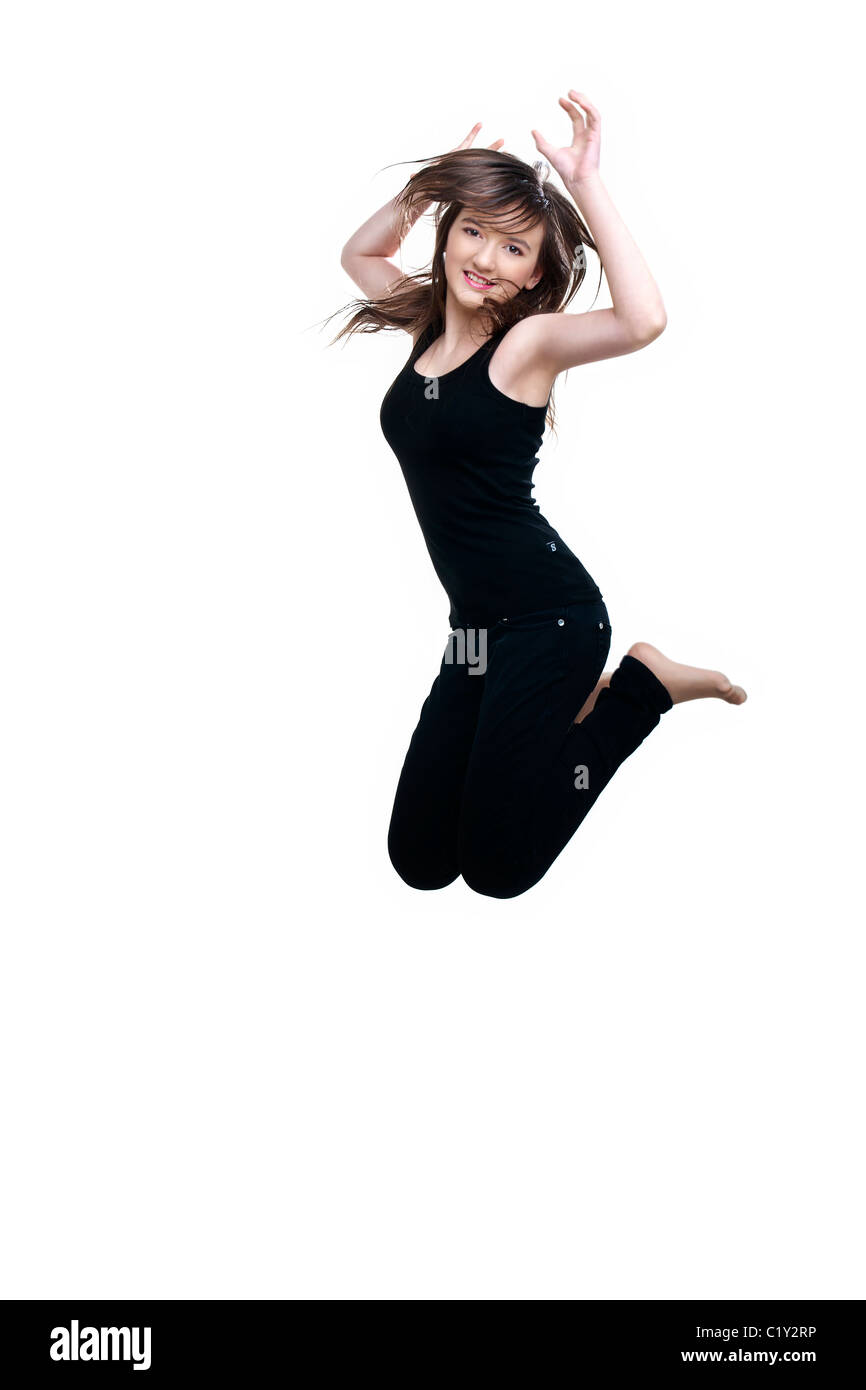 girl dressed in black jumping on white background Stock Photo - Alamy