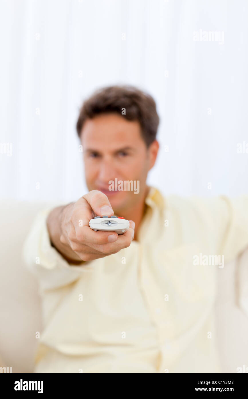 Serious man holding remote control Stock Photo - Alamy