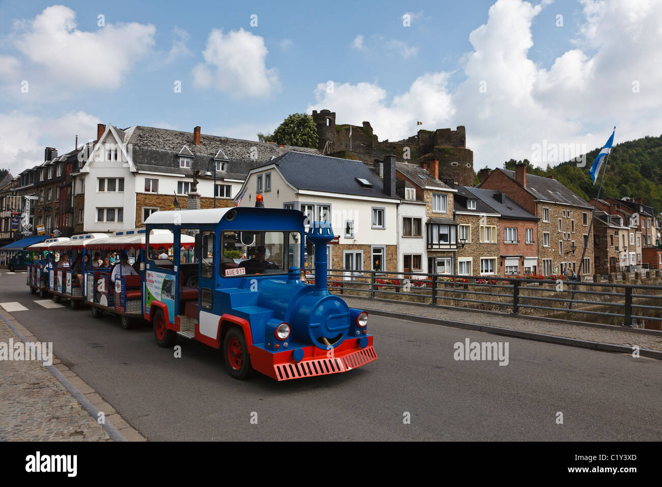 Tourist road train crossing the bridge over the River Ourthe at La ...