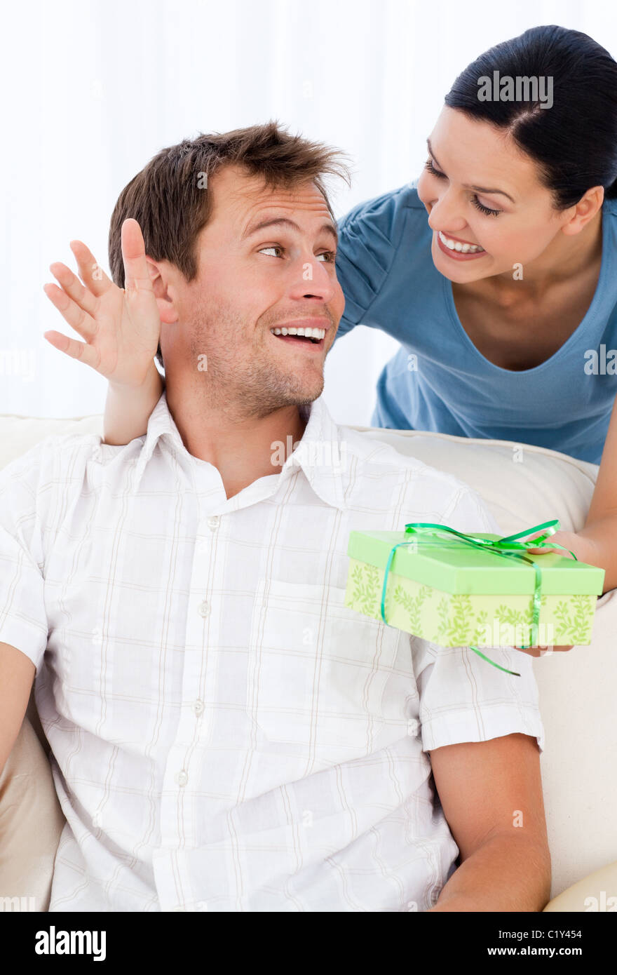 Amazed man receiving a present from his girlfriend Stock Photo - Alamy