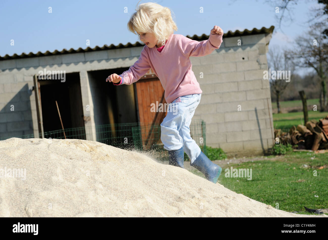 Stock Photo of a Five Year old Girl Running Across a Pile of Sand Stock ...
