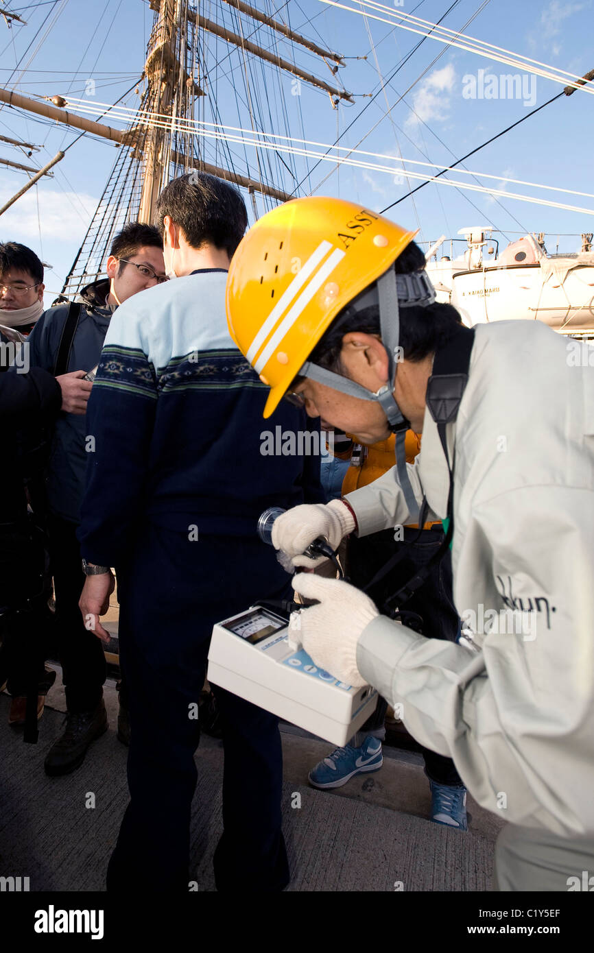 A member of the so-called Fukushima 50 is given a radiation check prior ...